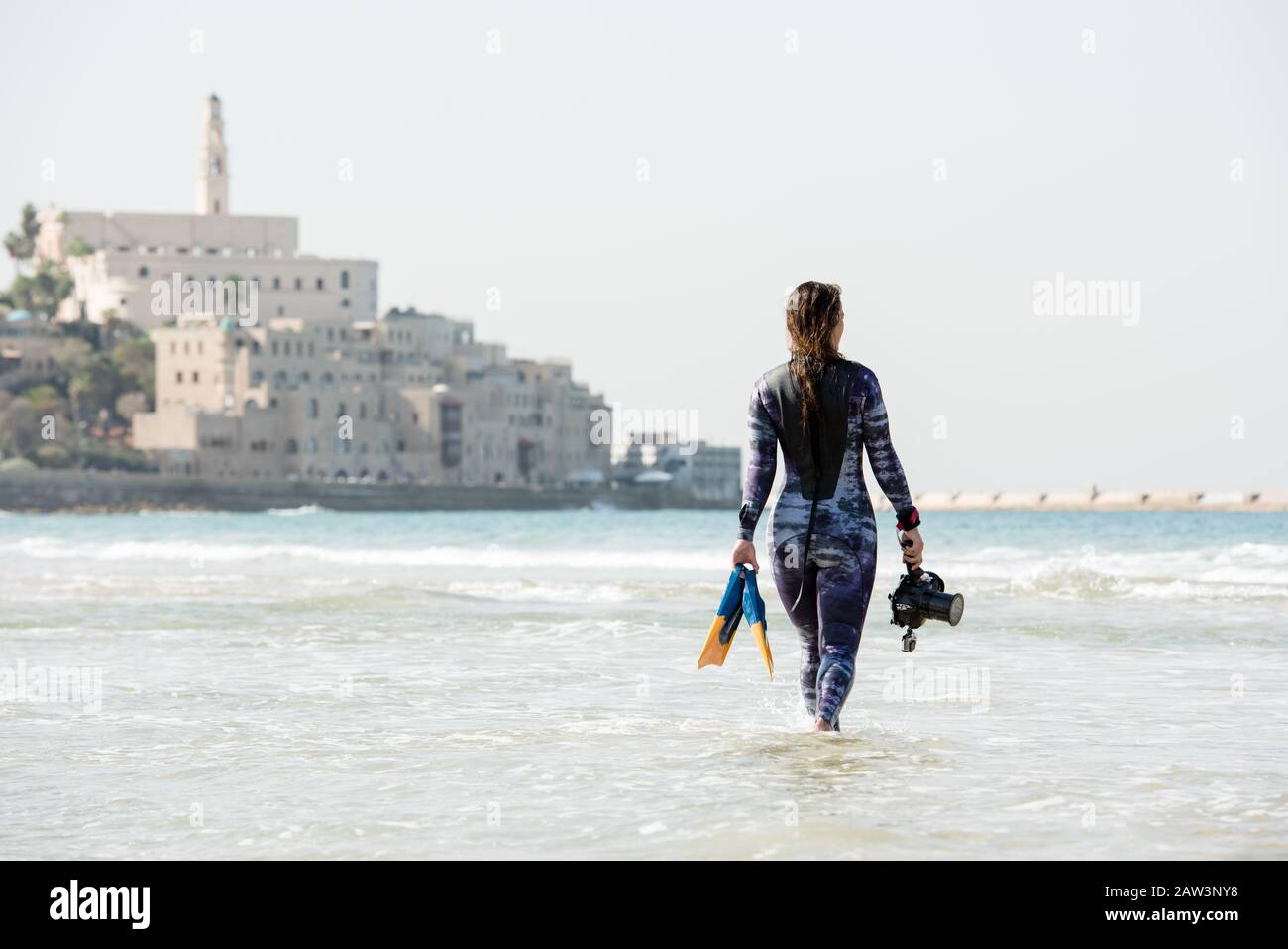 Female water photographer heads out into bright blue waters Stock Photo ...