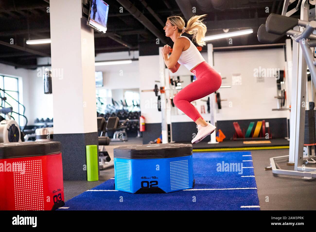 A woman box jumping in the gym Stock Photo - Alamy