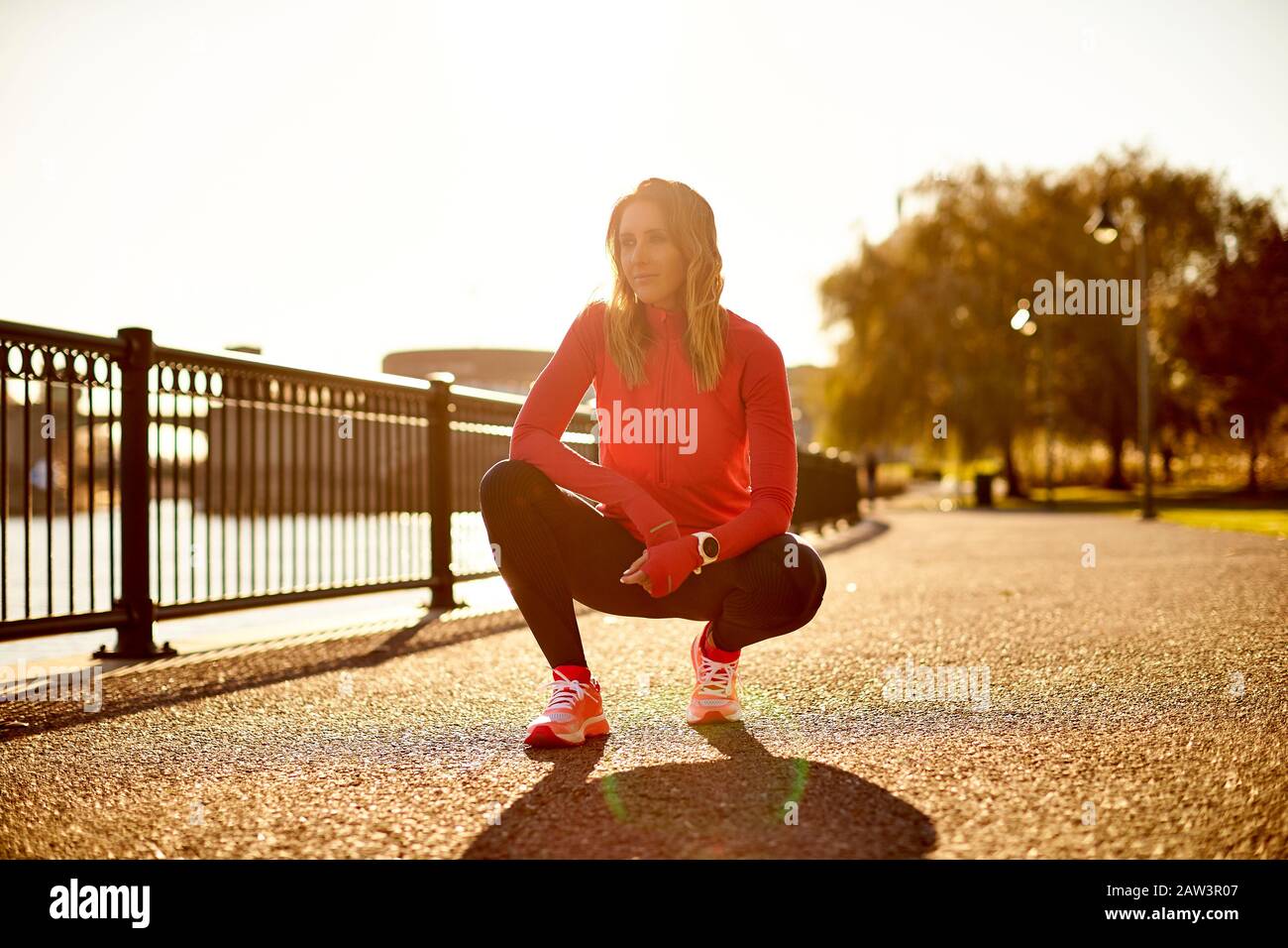 A backlit portrait of a female runner at rest Stock Photo - Alamy