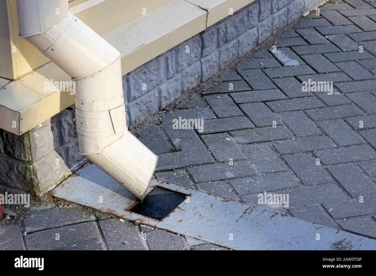 Rainwater drainage system on the sidewalk closeup Stock Photo - Alamy