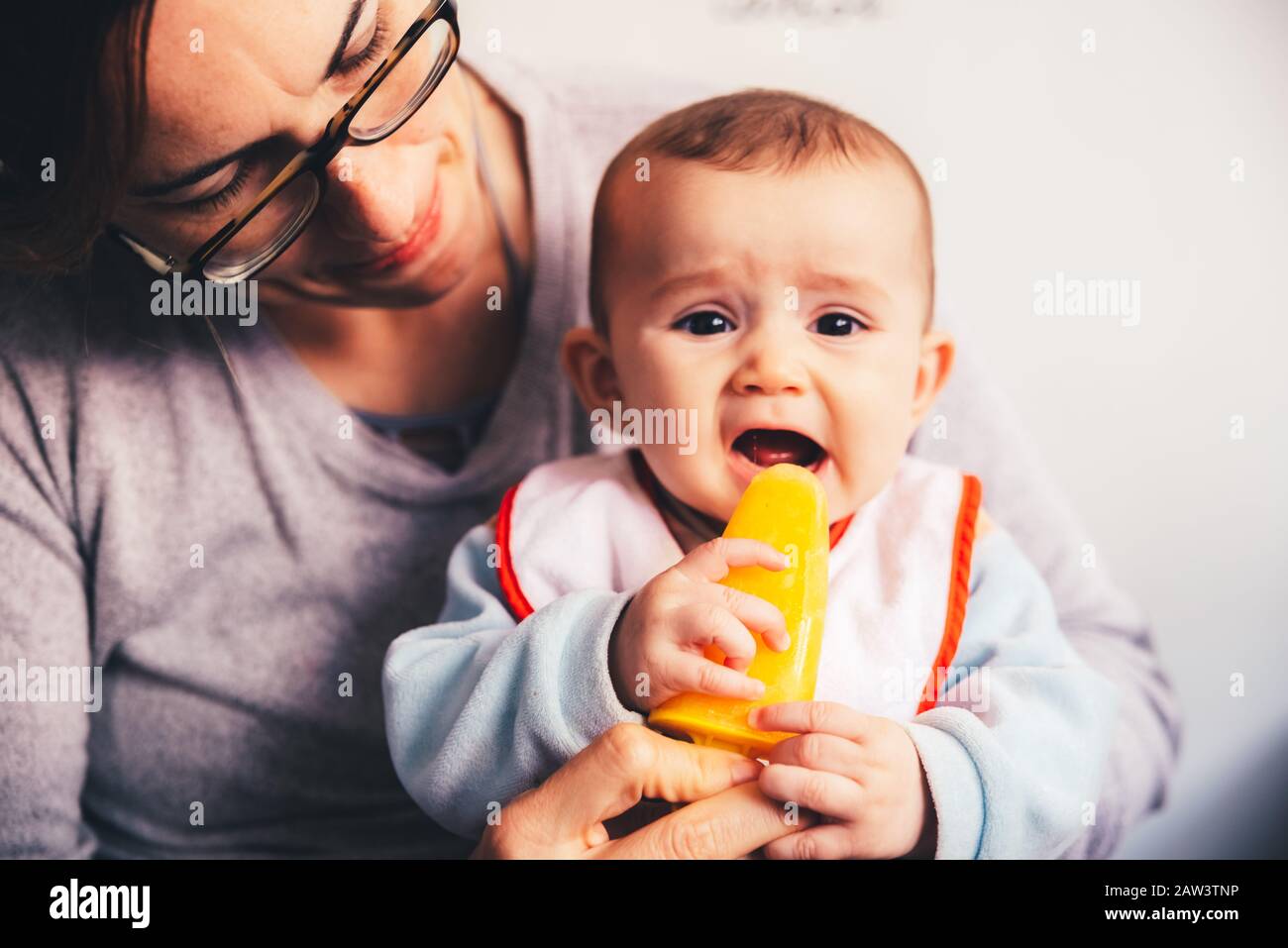Baby smiling and drooling when trying for the first time an ice cream ...