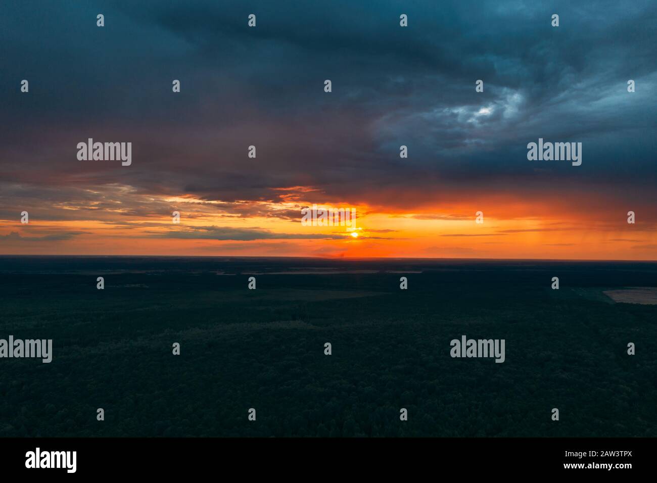 Aerial View Of Sunset Sky Above Green Forest Landscape In Evening. Top ...