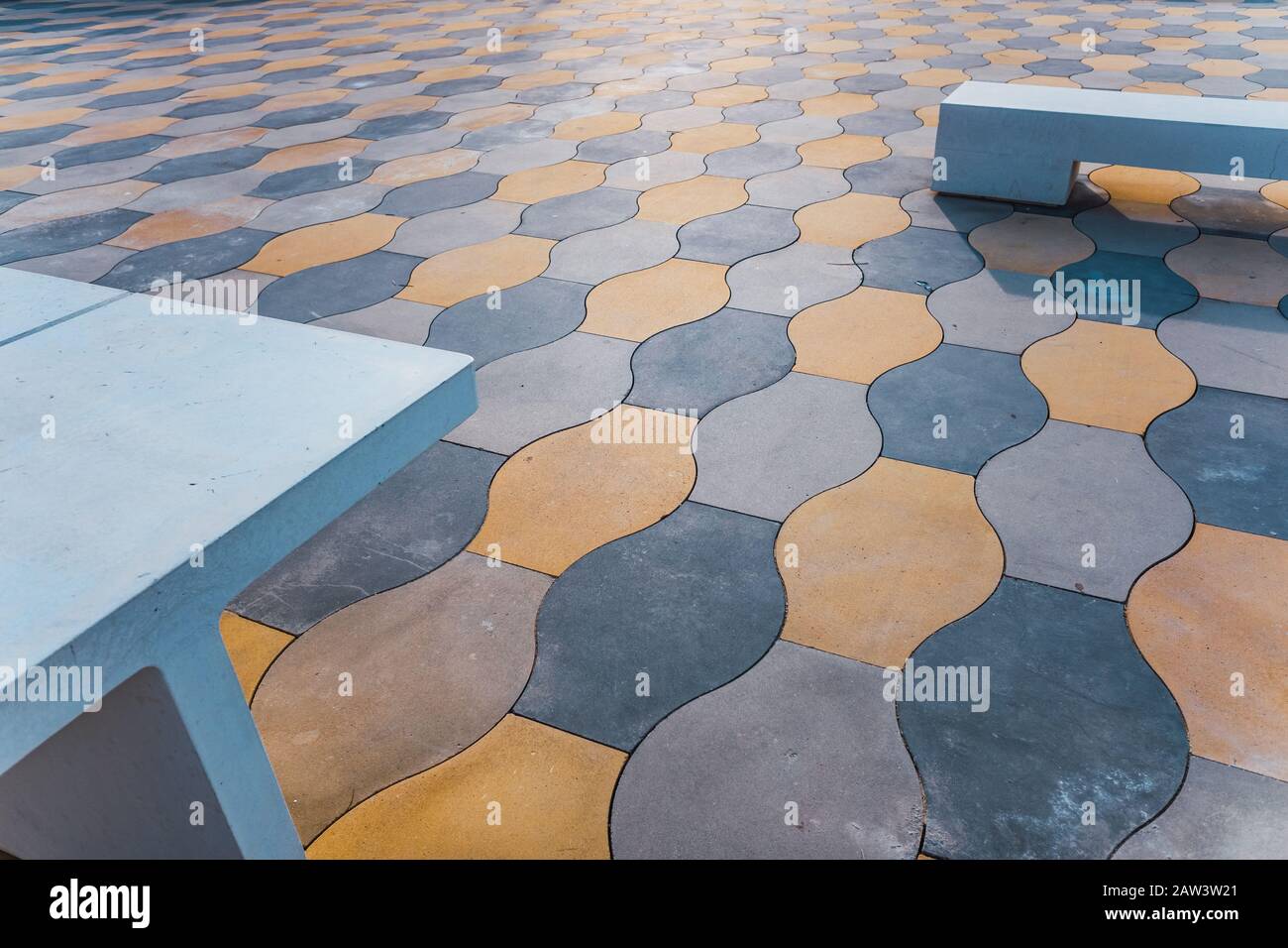 Pavement embedded in pieces of different colors on the floor of a park ...