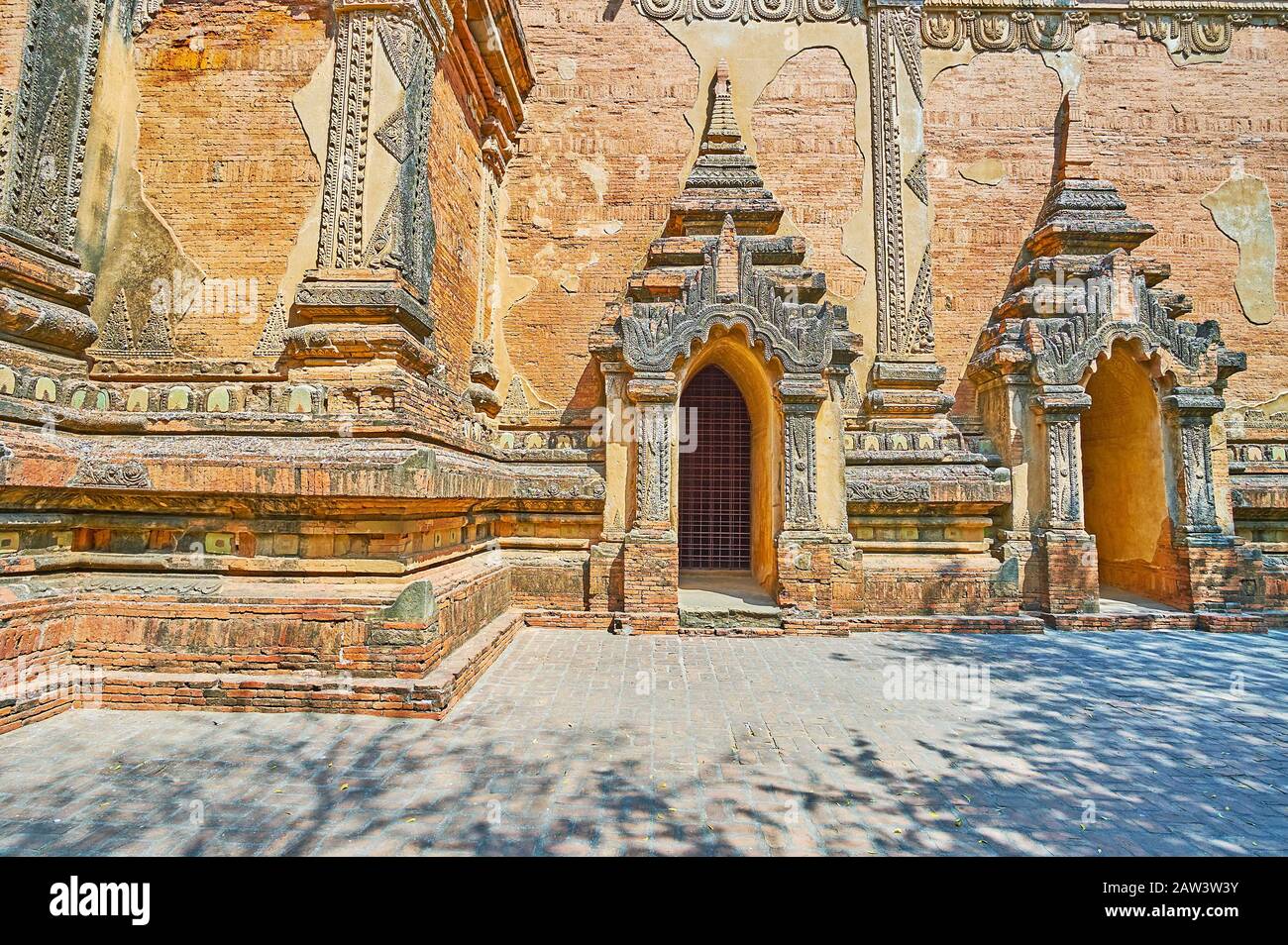The ancient wall of Htilominlo Temple with complex relief door frames ...