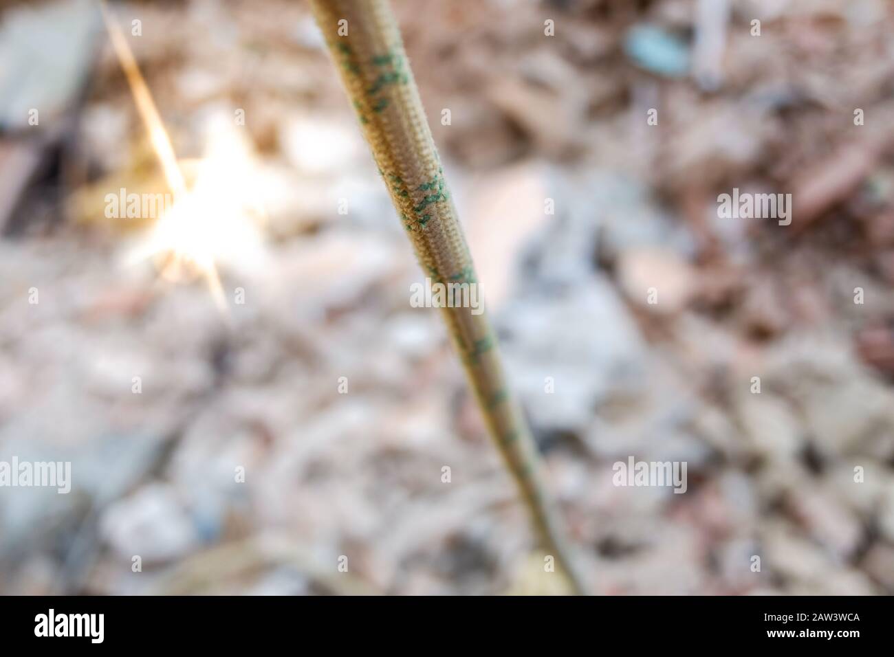 Rope falling vertically illuminated by a sun flare Stock Photo - Alamy