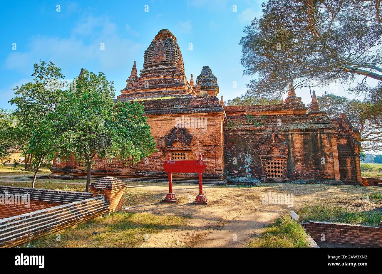 The ancient temple with damaged stupa-like tower, carved brick window ...