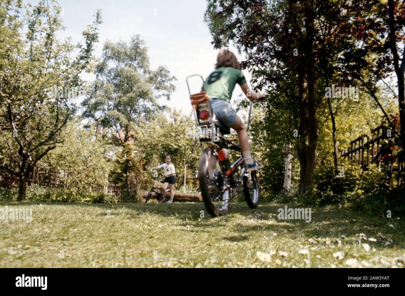A brother and sister playing on their Raleigh Chopper American export ...