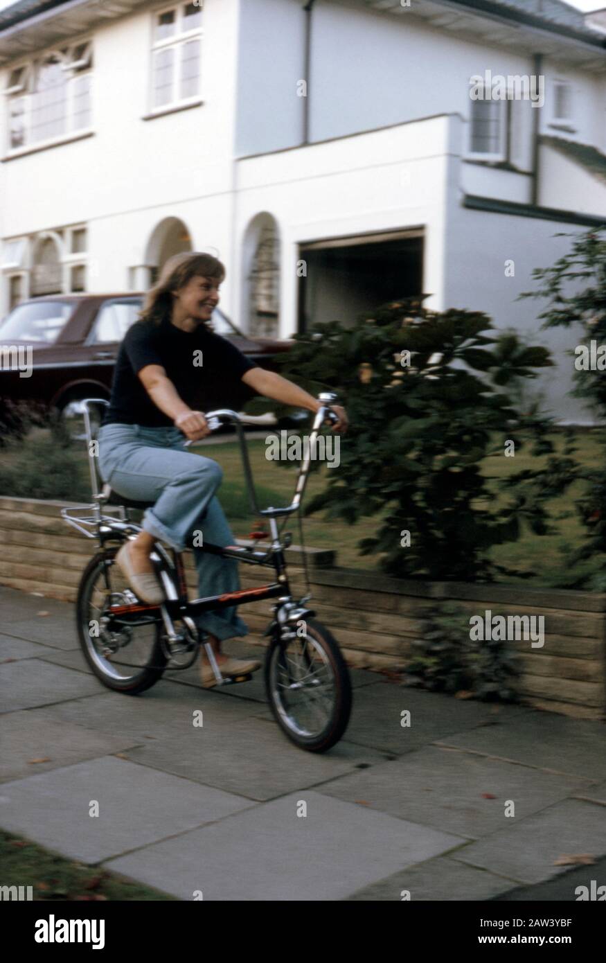 A mum having a ride on her son's new Raleigh Chopper American export ...