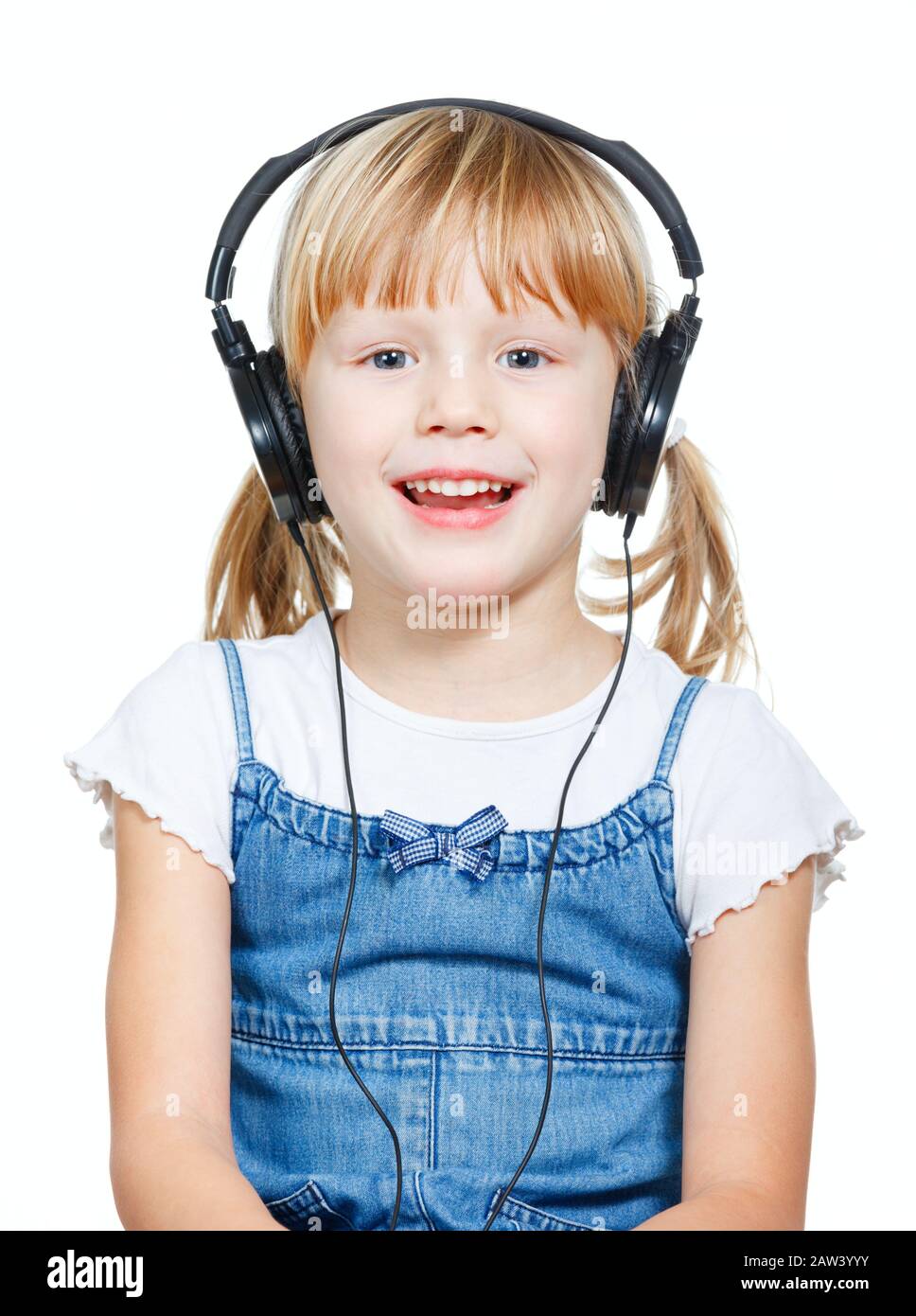 Portrait of cute 4 years girl wearing headphones over a white ...