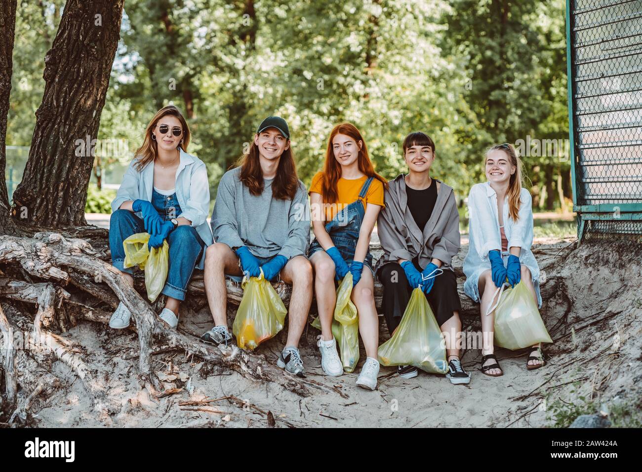 Group of activists friends collecting plastic waste at the park ...
