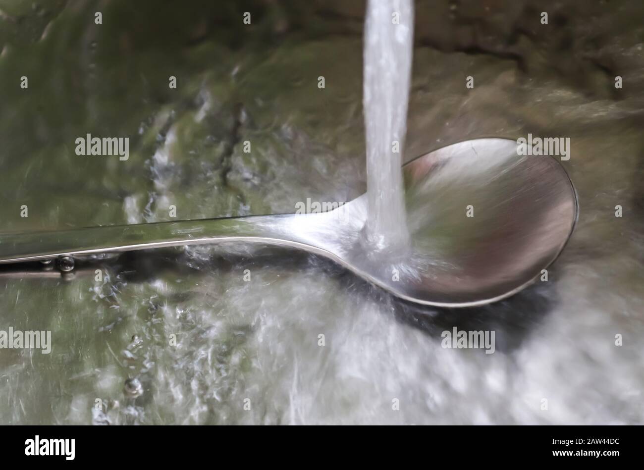 Running water out of a water tap in a metallic kitchen sink Stock Photo ...