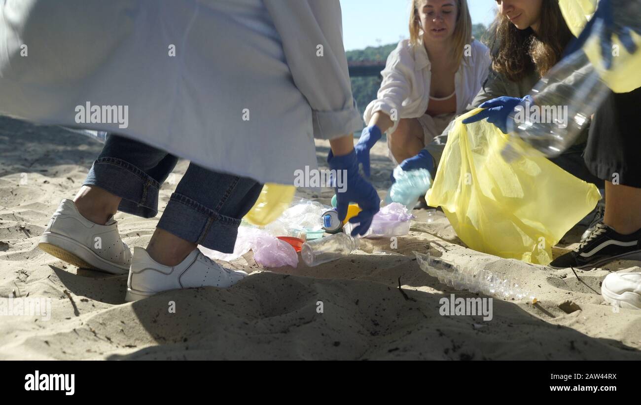 Group of activists friends collecting plastic waste on the beach ...