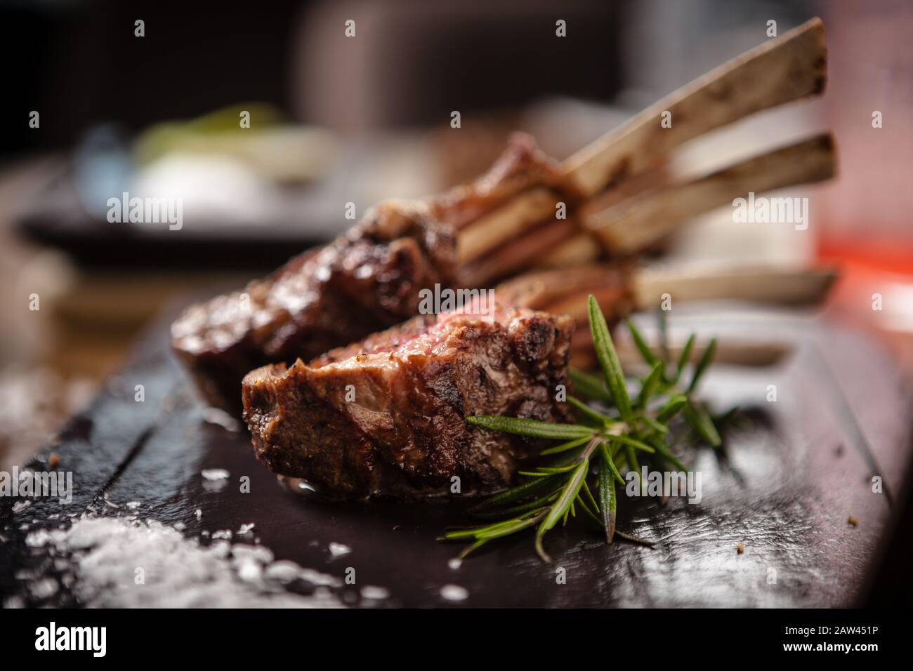 Grilled lamb chops served with a branch of rosemary Stock Photo - Alamy