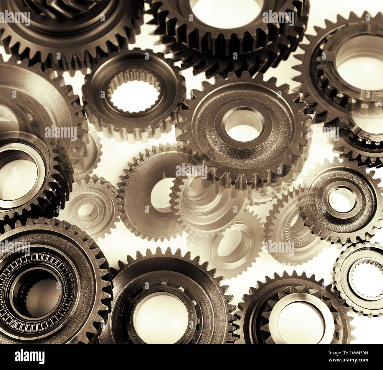 Metal cog gears joining together Stock Photo - Alamy