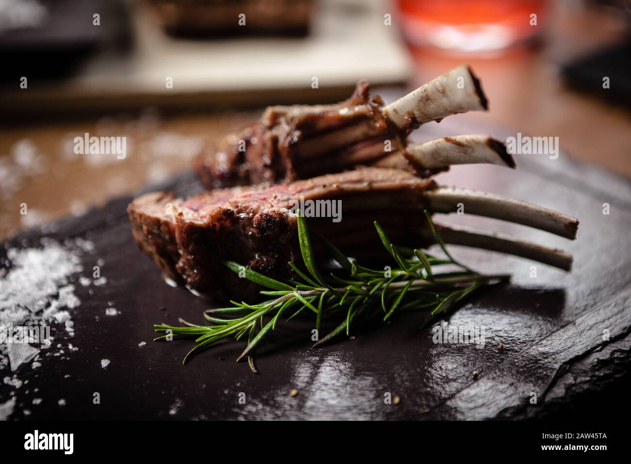 Grilled lamb chops served with a branch of rosemary Stock Photo - Alamy