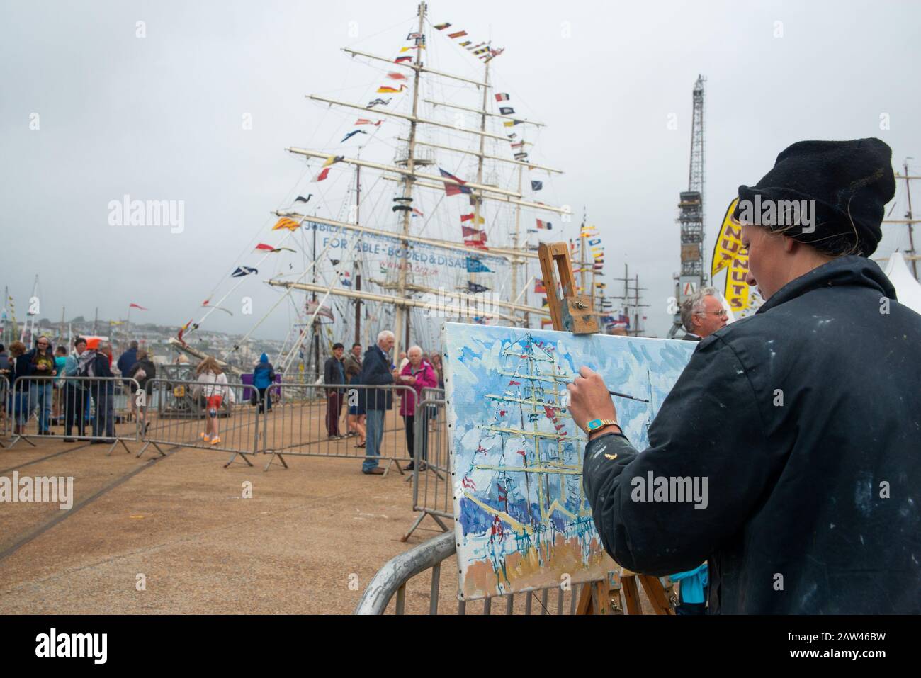 lady artist painting on an easel in the open air of a twin masted ship ...