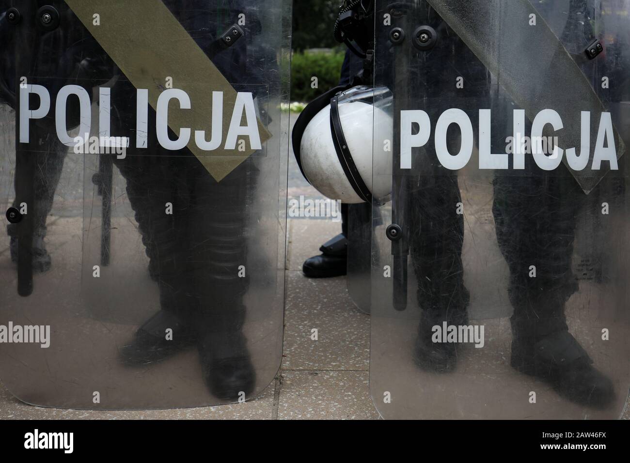 Polish policemen in action protect demonstrating people, white helmets ...