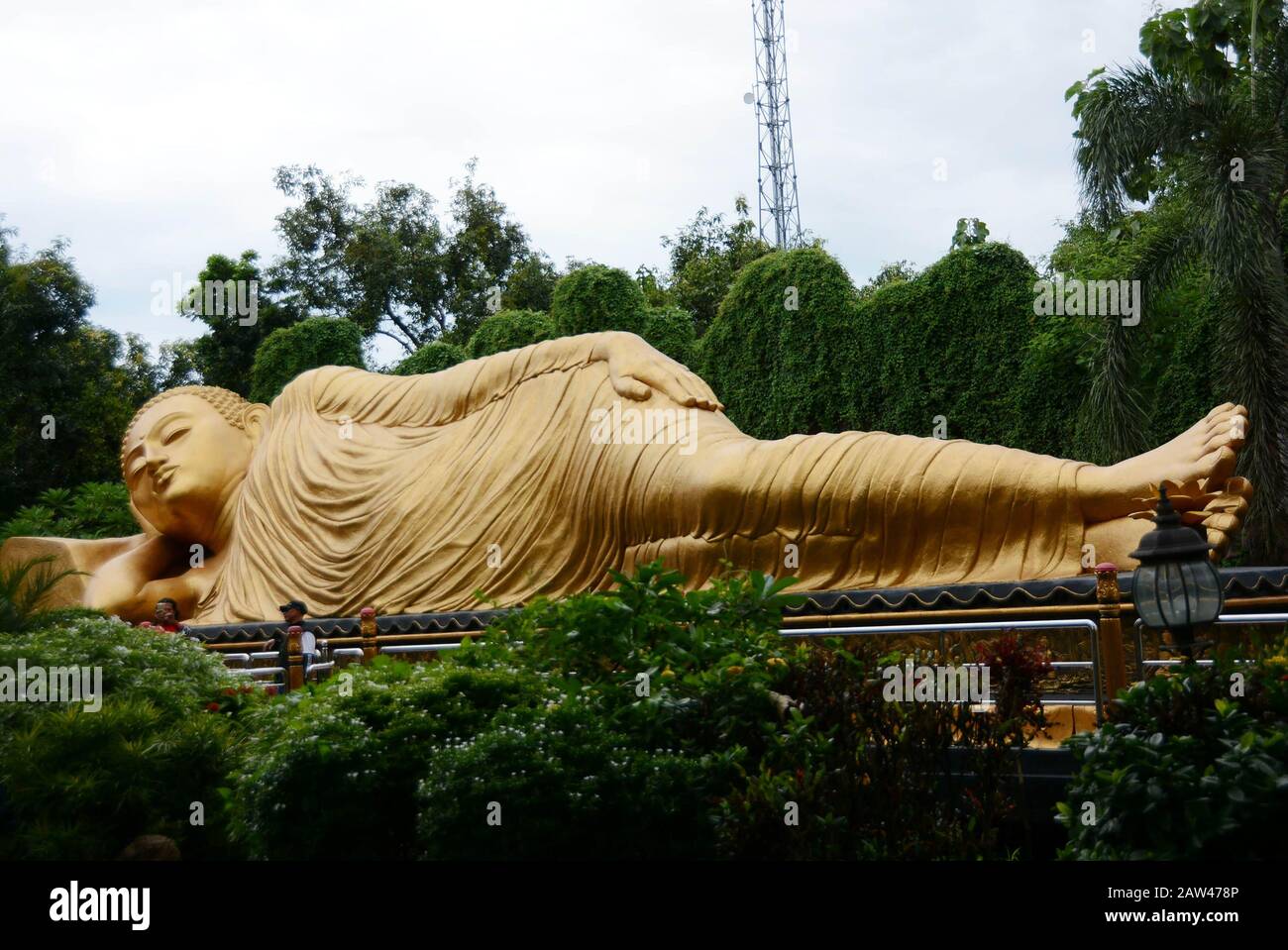 Local tourists visit the sleeping Buddha statue at Maha Vihara ...