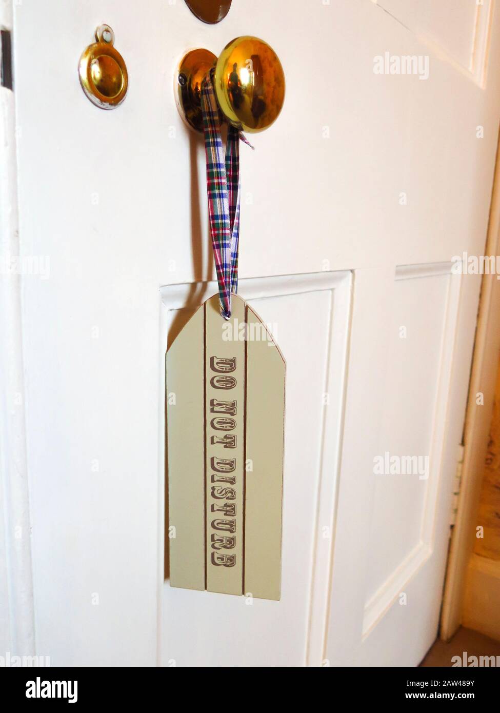 Fancy Do Not Disturb tag with tartan ribbon on door handle Stock Photo ...