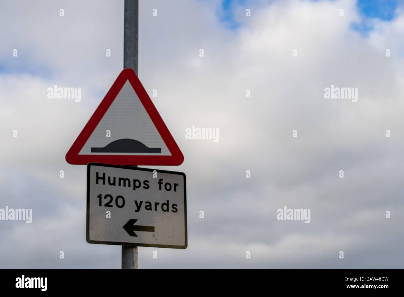 a speed hump warning sign Stock Photo - Alamy