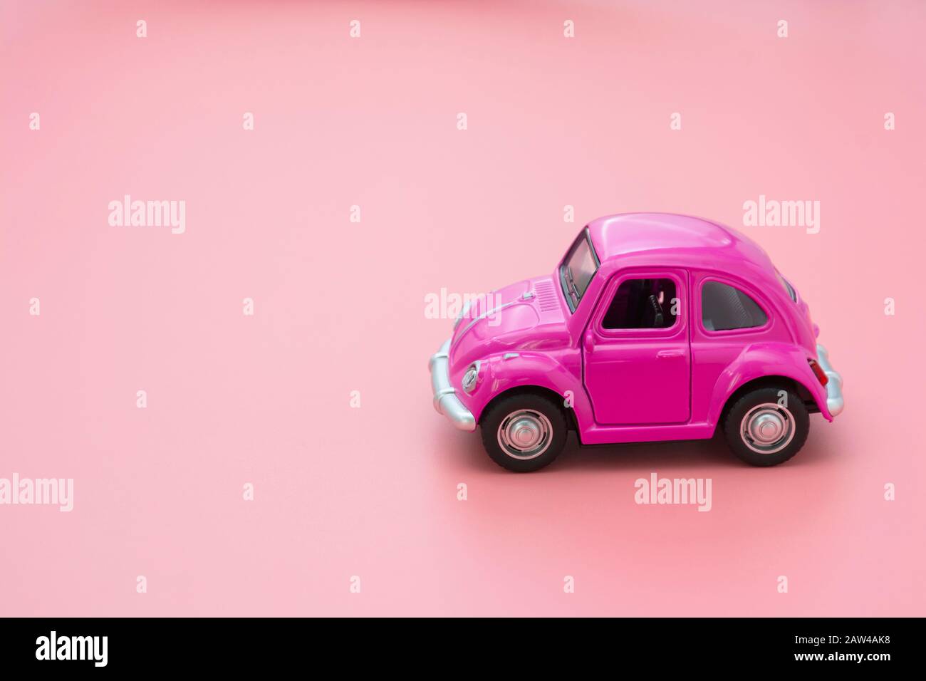 Miniature pink toy car on pink background. Minimal concept. Greeting ...