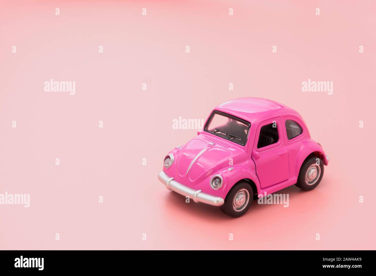 Miniature pink toy car on pink background. Minimal concept. Greeting ...