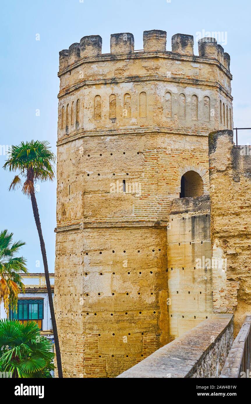The tall Octagonal tower of Alcazar fortress with damaged walls, belt ...