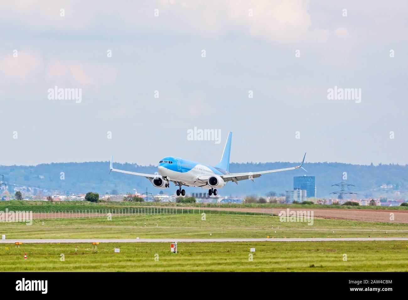 airplane on landing approach to airport - green meadow in front Stock ...