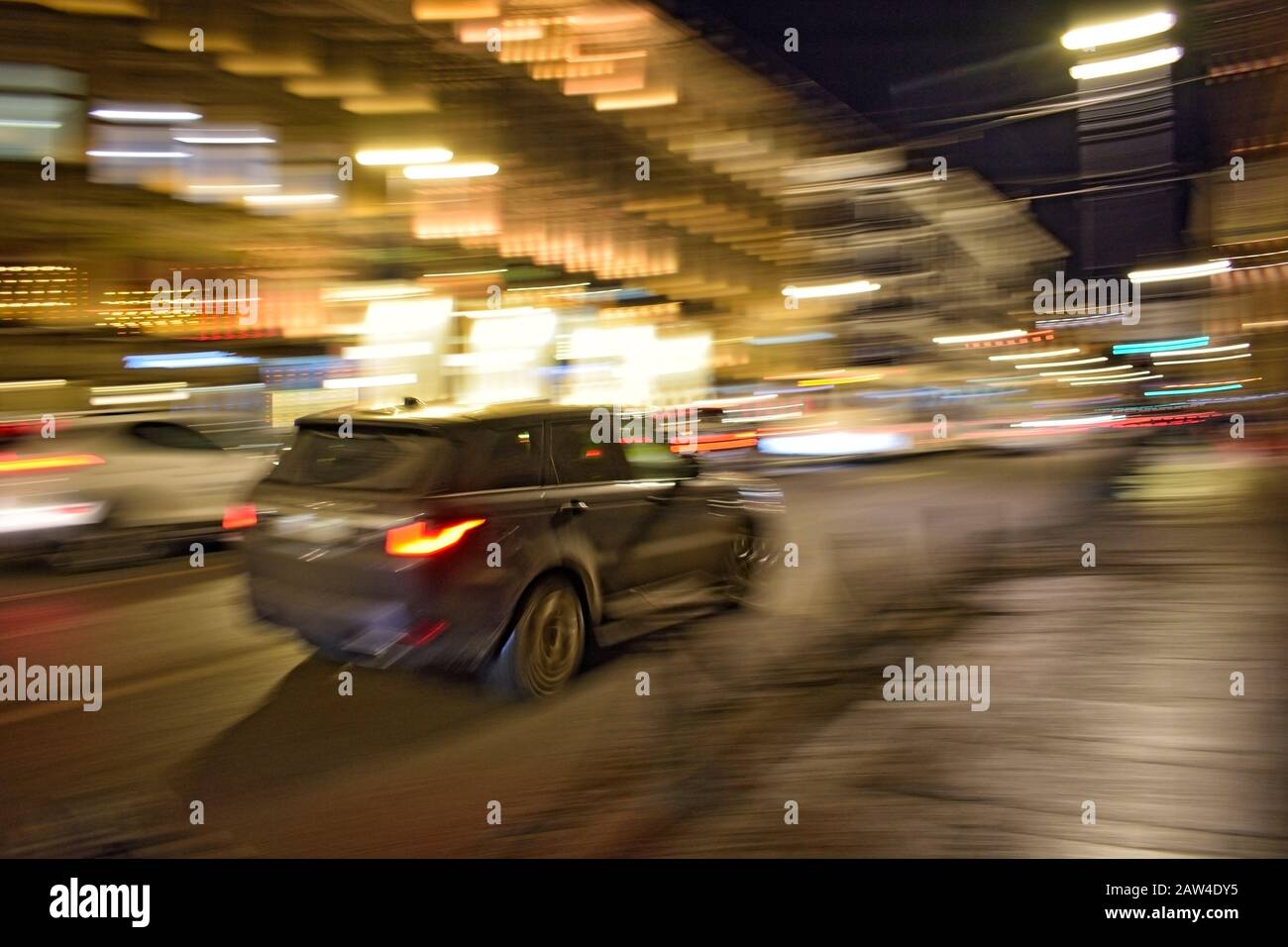 High-speed car driving.On the streets of the city glow electric lights ...