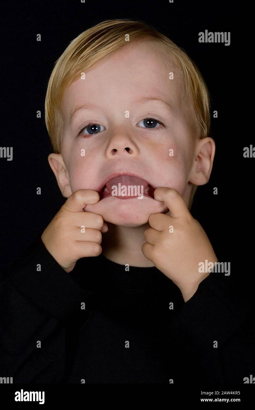 A young boy makes a silly face Stock Photo - Alamy