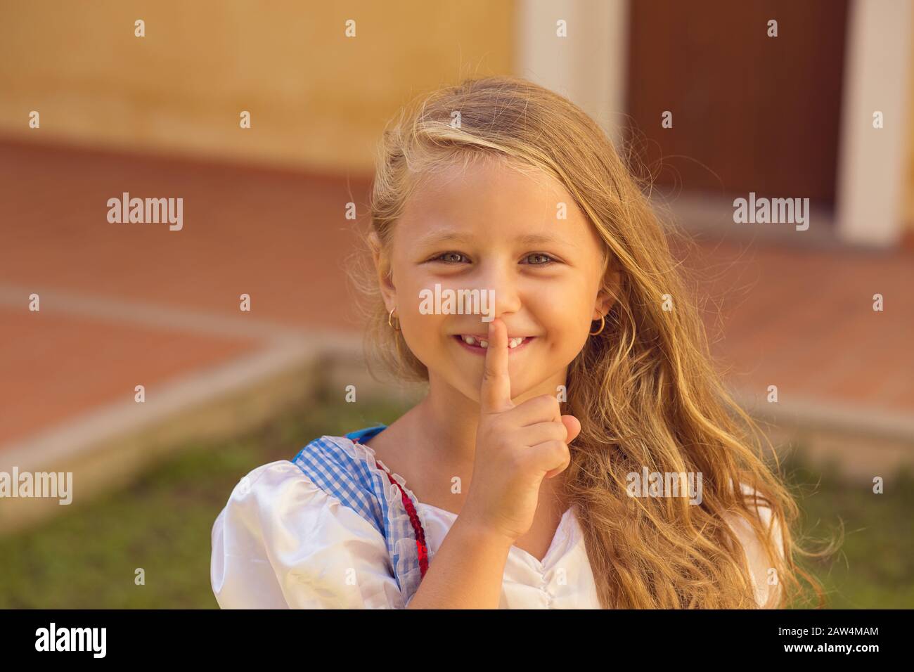 Keep silent mom is sleeping. The little girl shh gestures or shows her ...