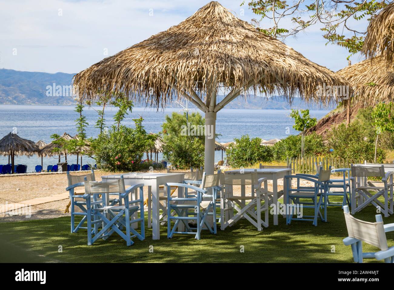 Palapa shading tables and chairs on Vlichos beach on Hydra Island, one ...