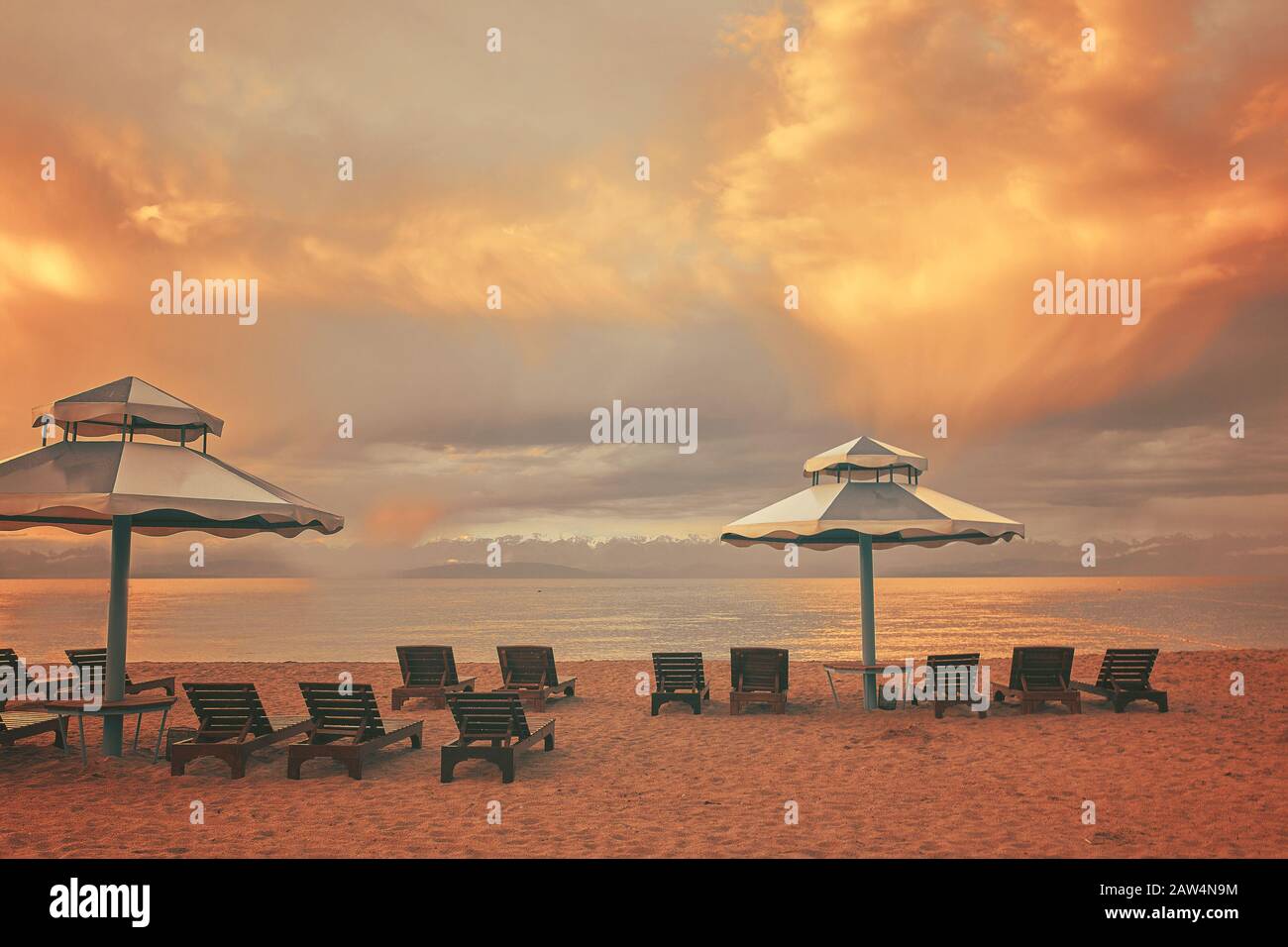 Sunbeds on the beach. Beautiful beach in the evening under the weak ...