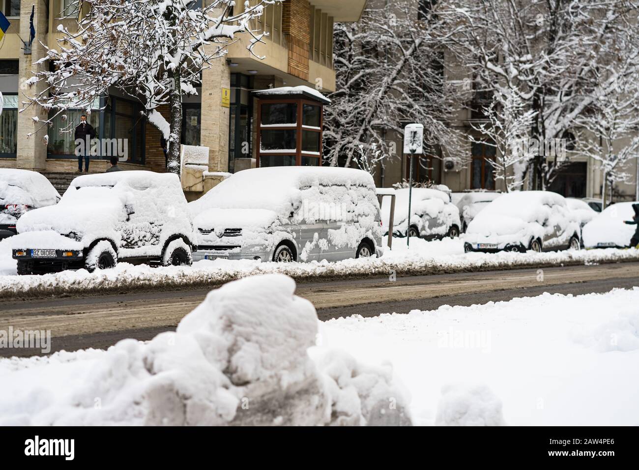 Snow on cars in the morning. Winter season and icy cars on the road in ...