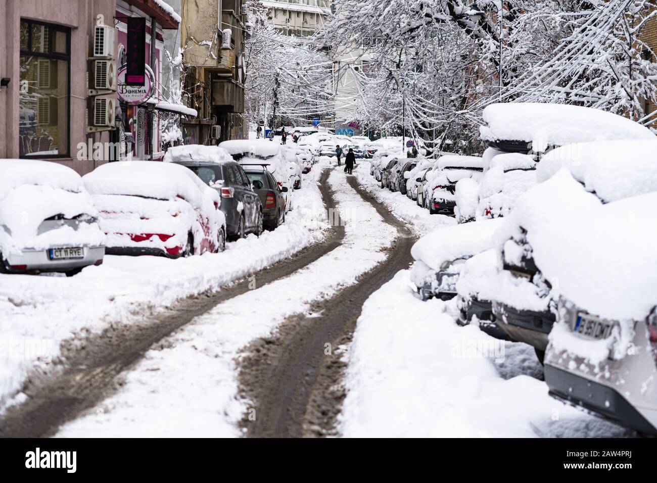 Snow on cars in the morning. Winter season and icy cars on the road in ...