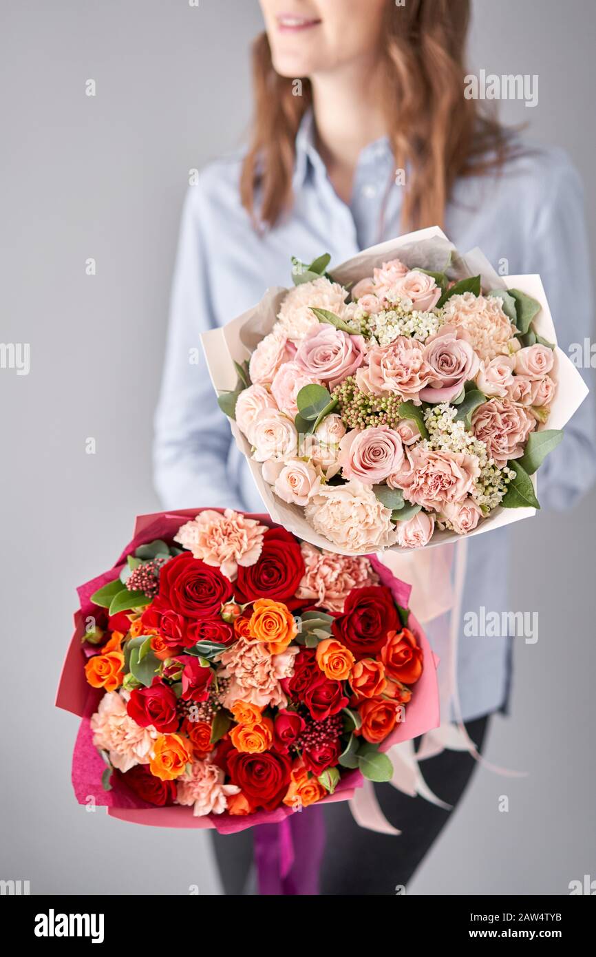 Two Beautiful bouquets of mixed flowers in womans hands. the work of ...