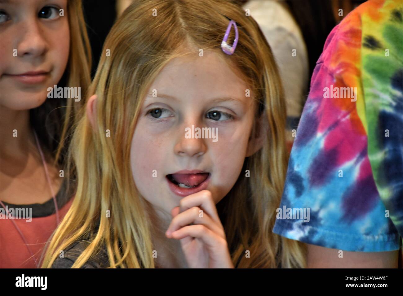 Girls at a public singing event watching other students Stock Photo - Alamy