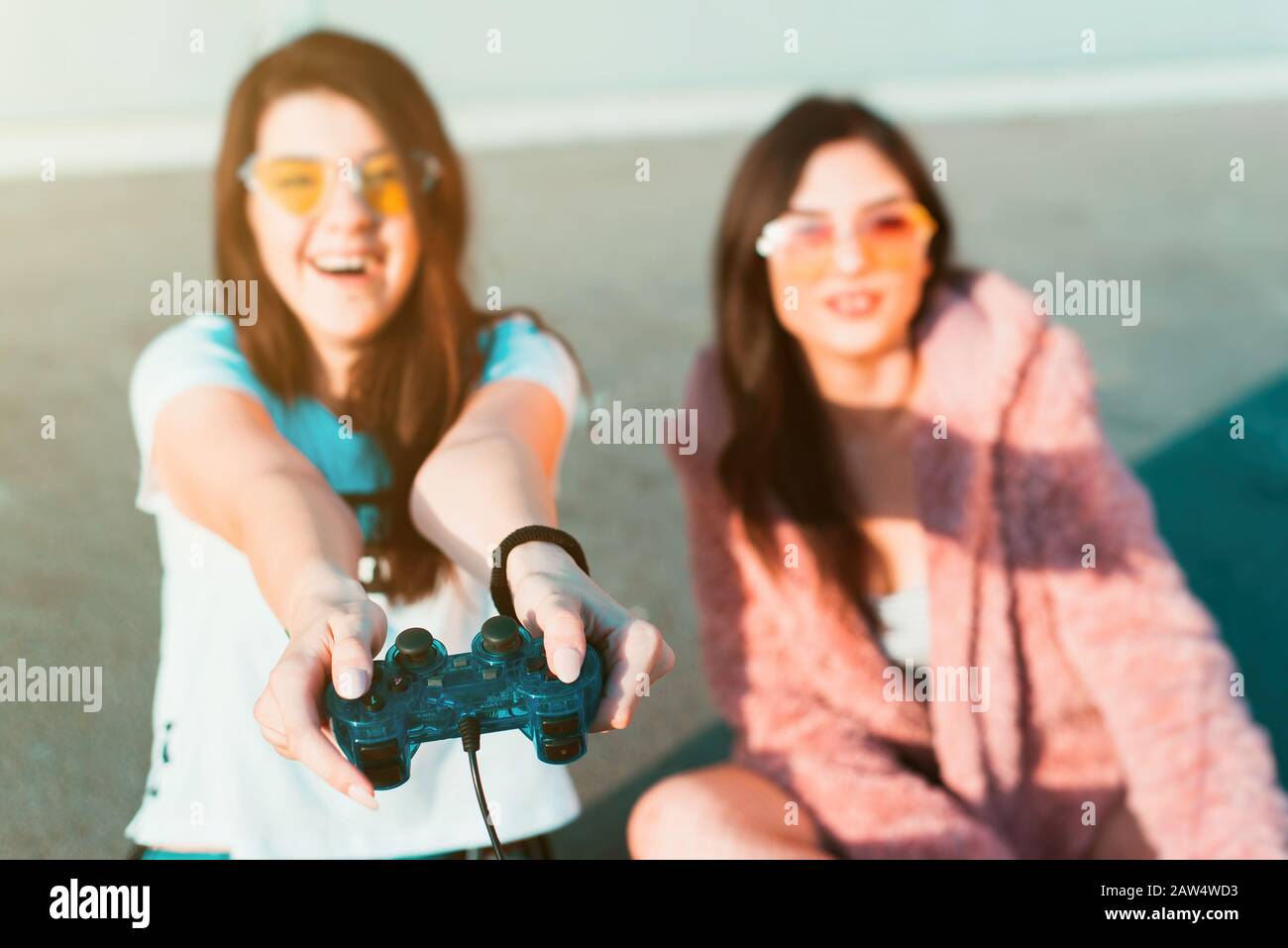 Two young women playing video games Stock Photo - Alamy