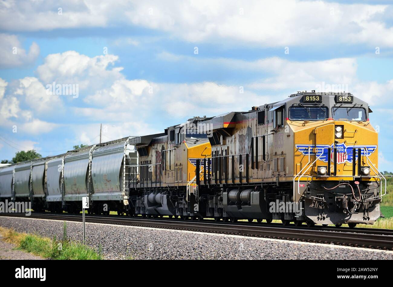 Elburn, Illinois, USA. A Union Pacific mixed freight train, lead by two locomotive units, passes ...