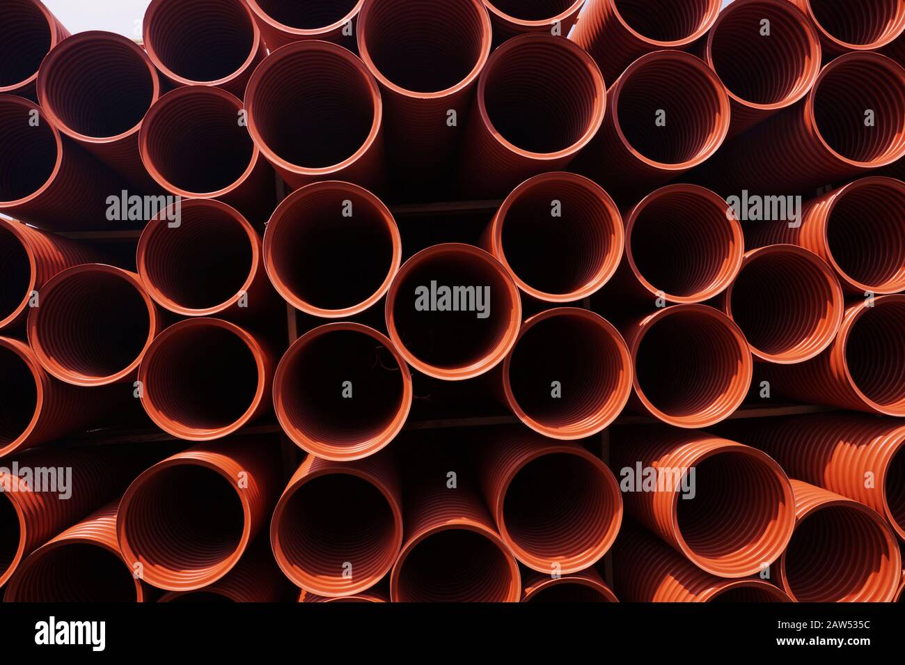 Composition of building materials. Sewer pipes stacked on shelves Stock ...
