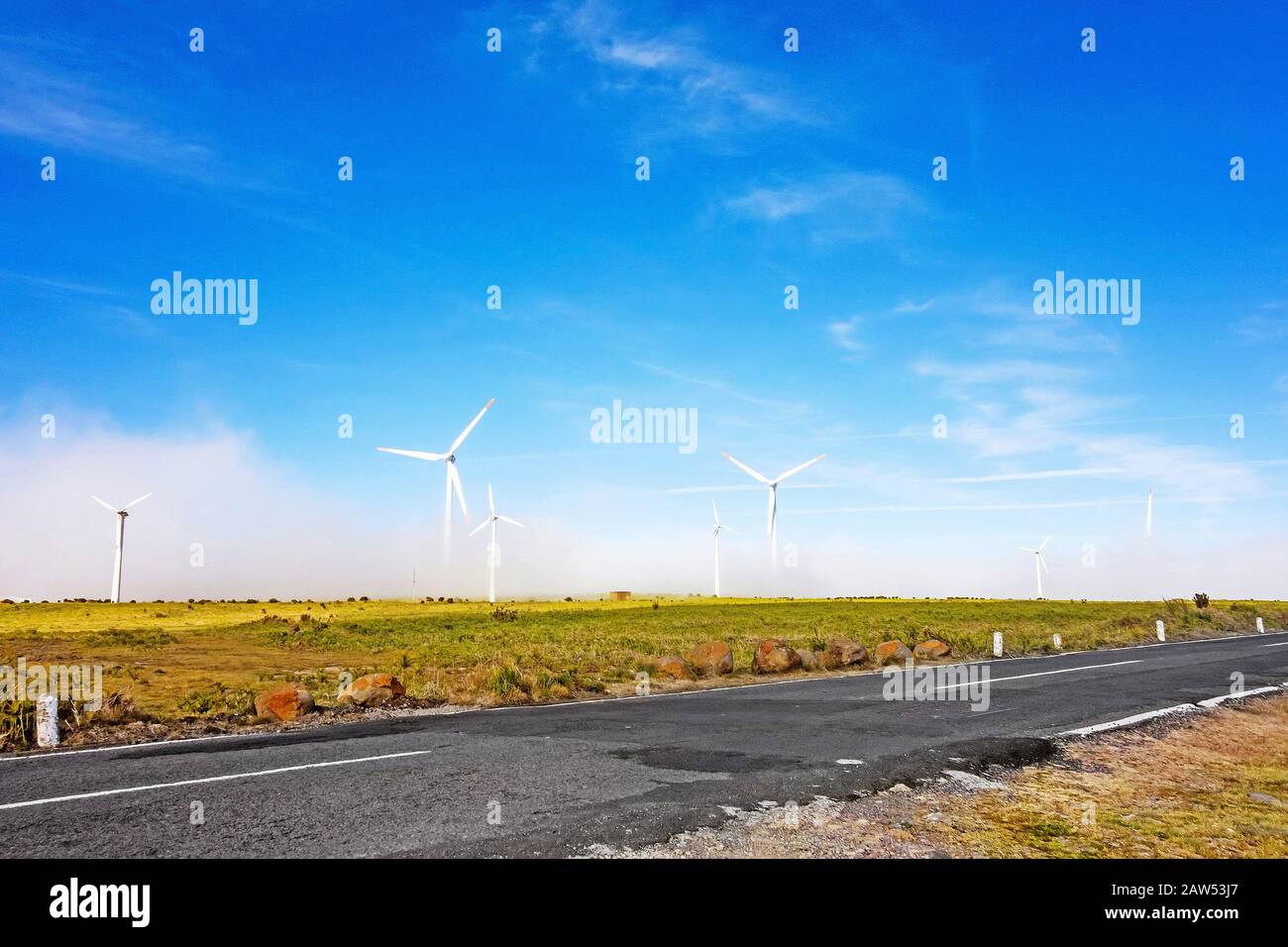 wind turbines along road - natural landscape Stock Photo - Alamy
