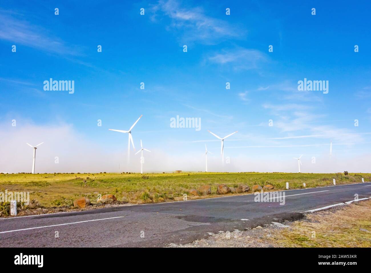 wind turbines along road - natural landscape Stock Photo - Alamy