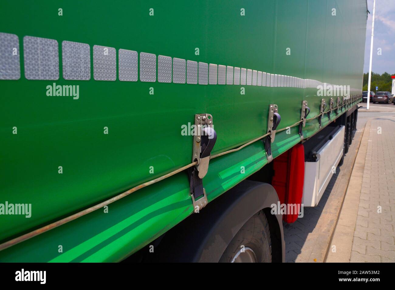 Transport and unloading. Semi-trailer with covered tarpaulin before ...