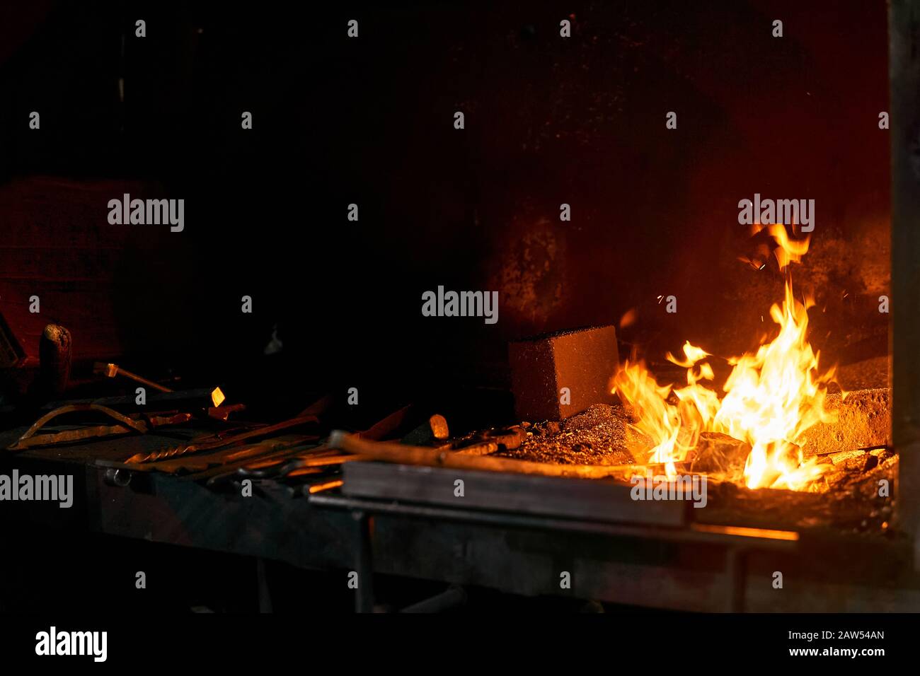 blacksmith furnace inner space with burning fire and forging tools ...