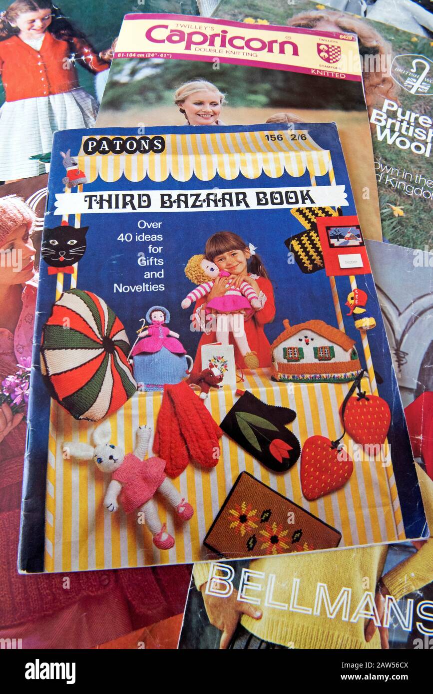 A pile of paper knitting patterns with Patons Third Bazaar Book on top ...