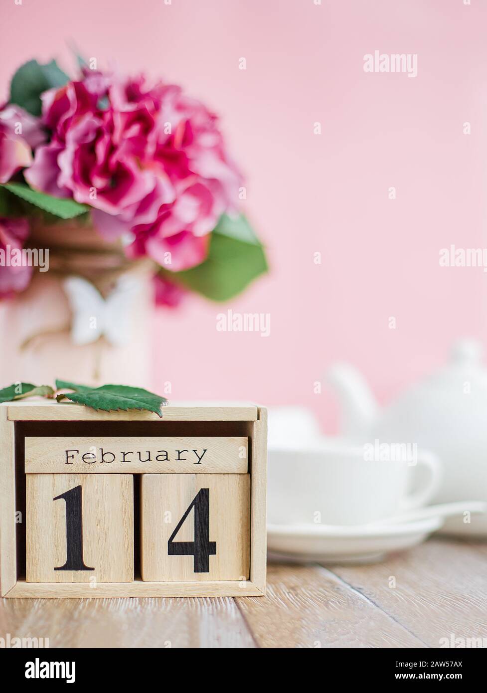 Happy Valentine's Day. Wooden calendar for February 14 with flowers a ...