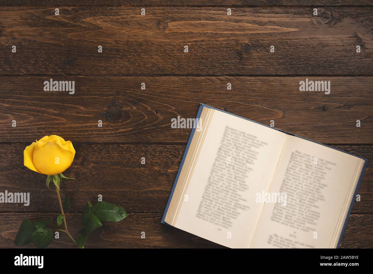 Romantic concept. Open book with poems and rose, on wooden background ...