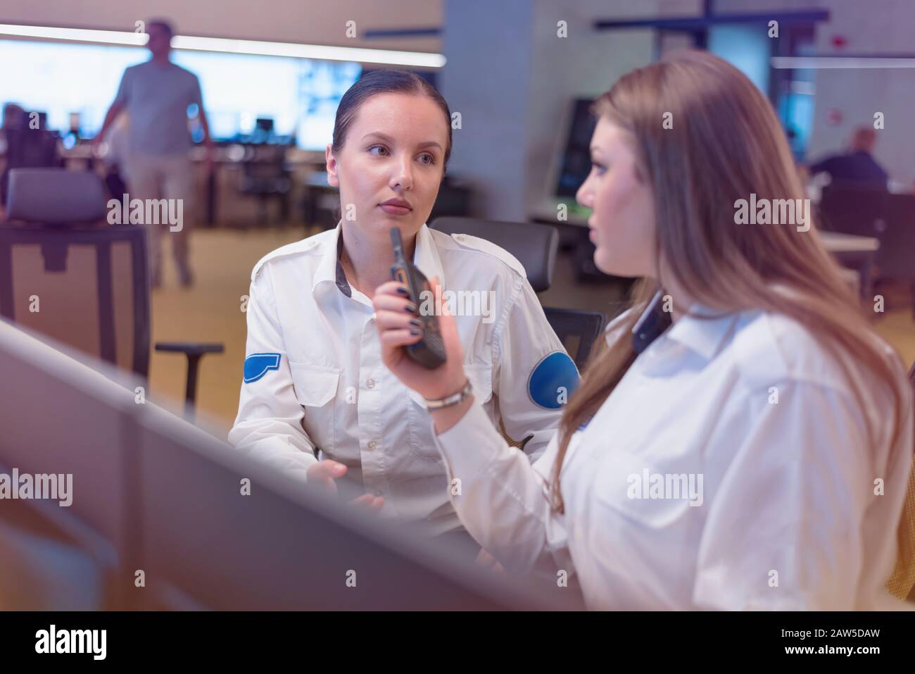 Security guard monitoring modern CCTV cameras in a surveillance room ...