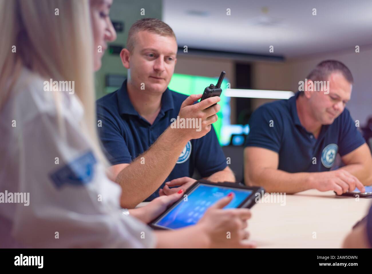 Security guard monitoring modern CCTV cameras in a surveillance room ...