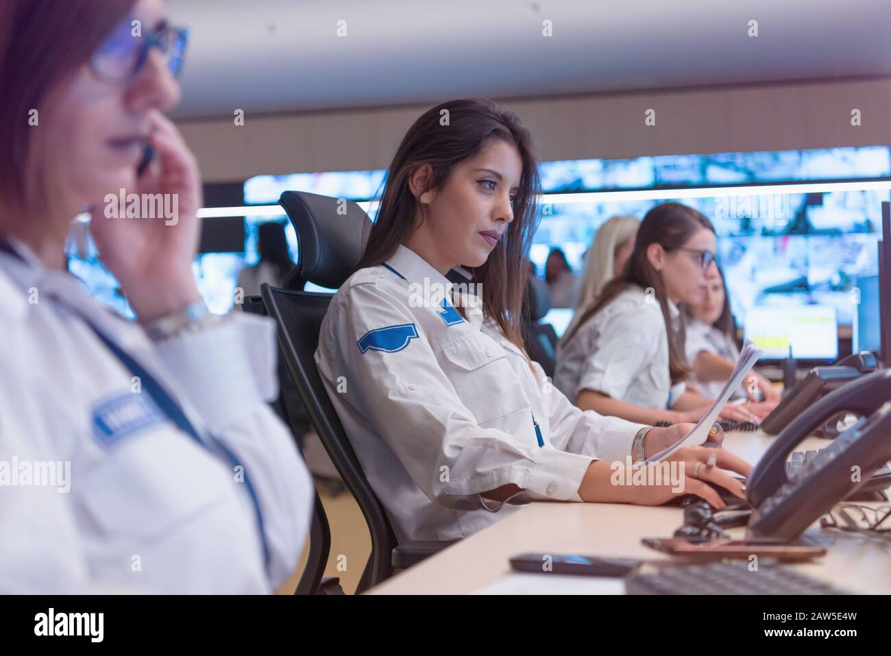 Security guard monitoring modern CCTV cameras in a surveillance room ...